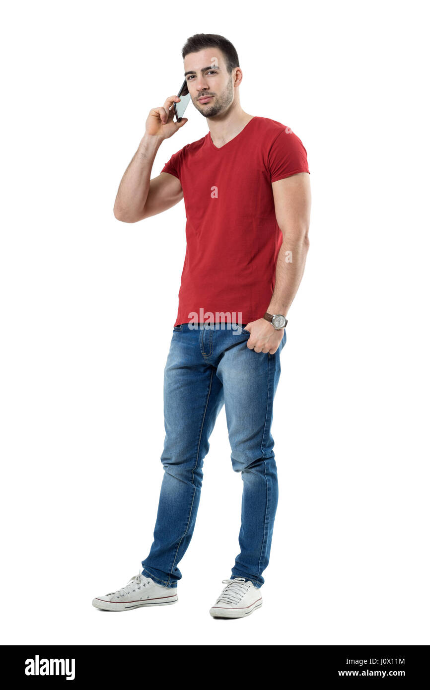 Confident young handsome man on the mobile phone looking at camera ...