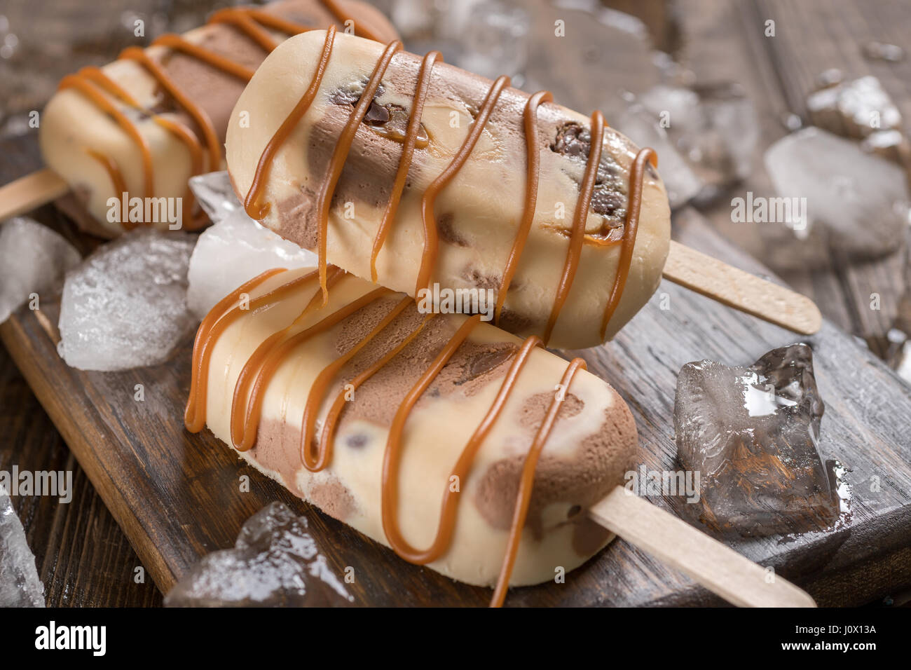 Delicious homemade caramel chocolate popsicles with candy Stock Photo ...