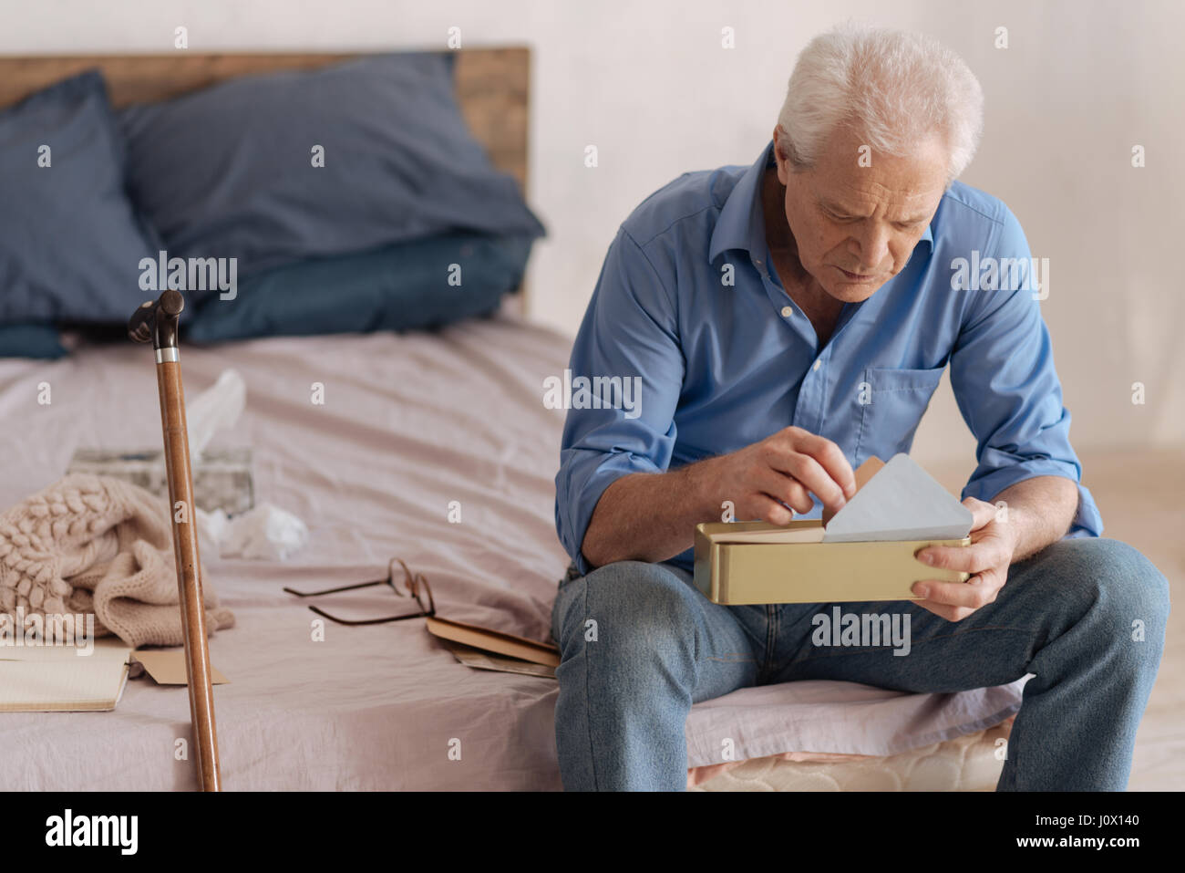 Depressed sad man holding a box with mail Stock Photo - Alamy