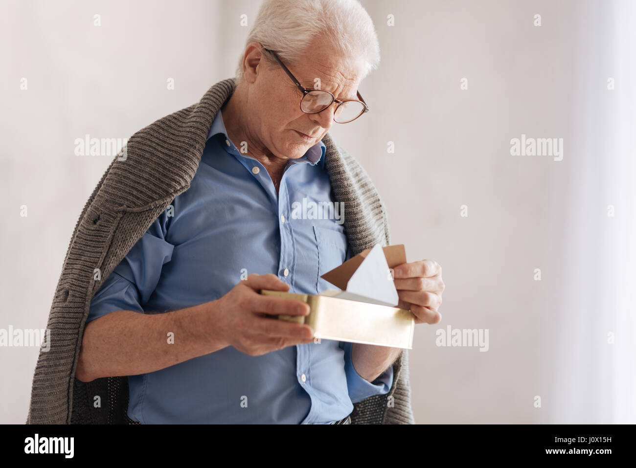 Nice elderly man being nostalgic about his past Stock Photo - Alamy