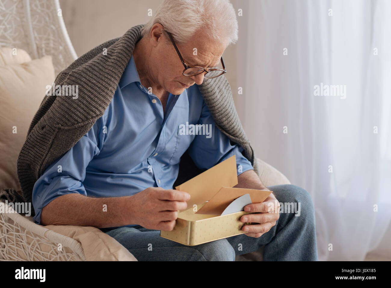 Sad nice man turning over his old letters Stock Photo - Alamy
