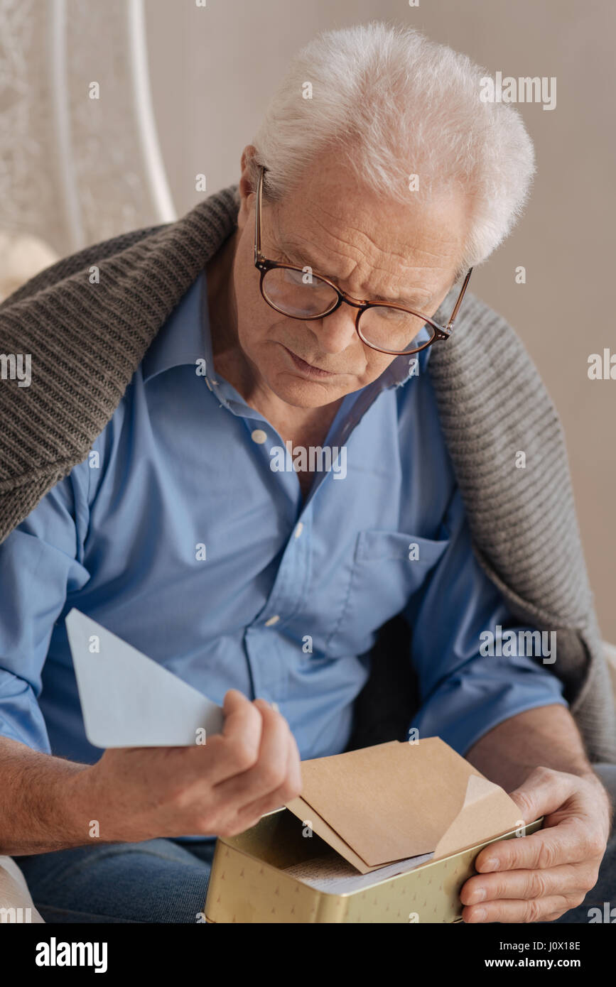 Unhappy sad man reading looking at the envelope Stock Photo - Alamy