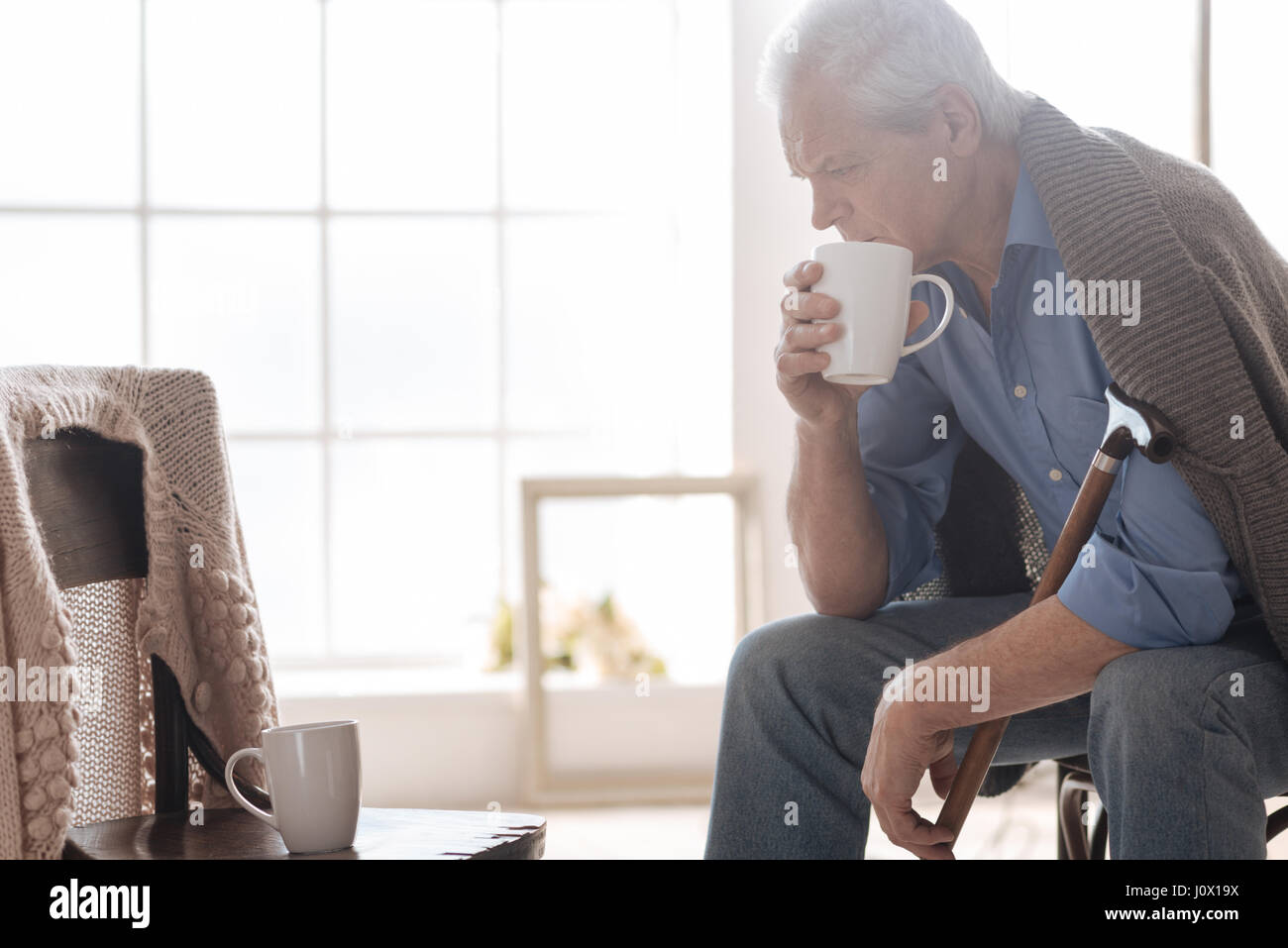 Desperate aged man looking at the empty chair Stock Photo - Alamy