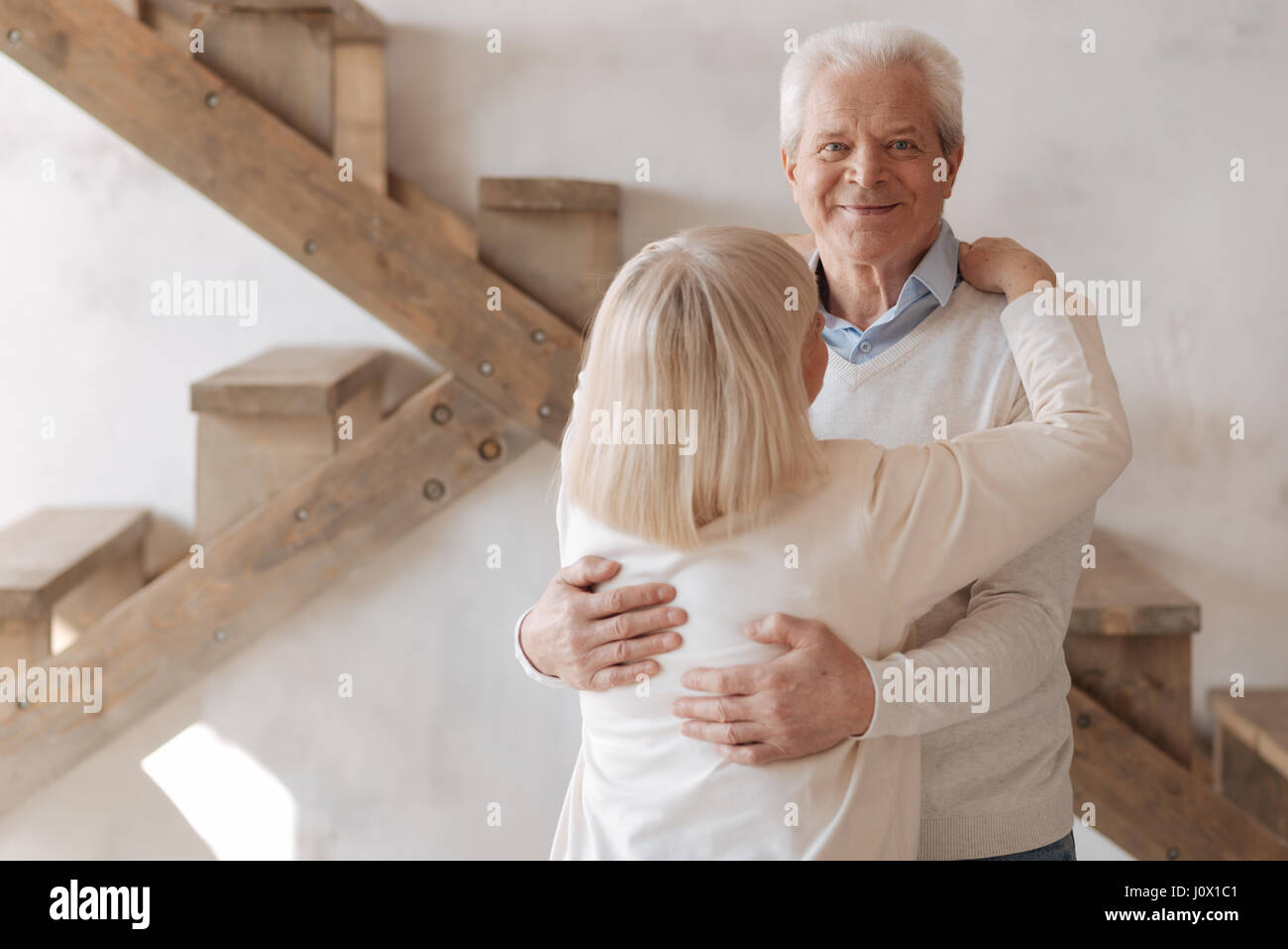 Delighted caring husband hugging his wife Stock Photo - Alamy
