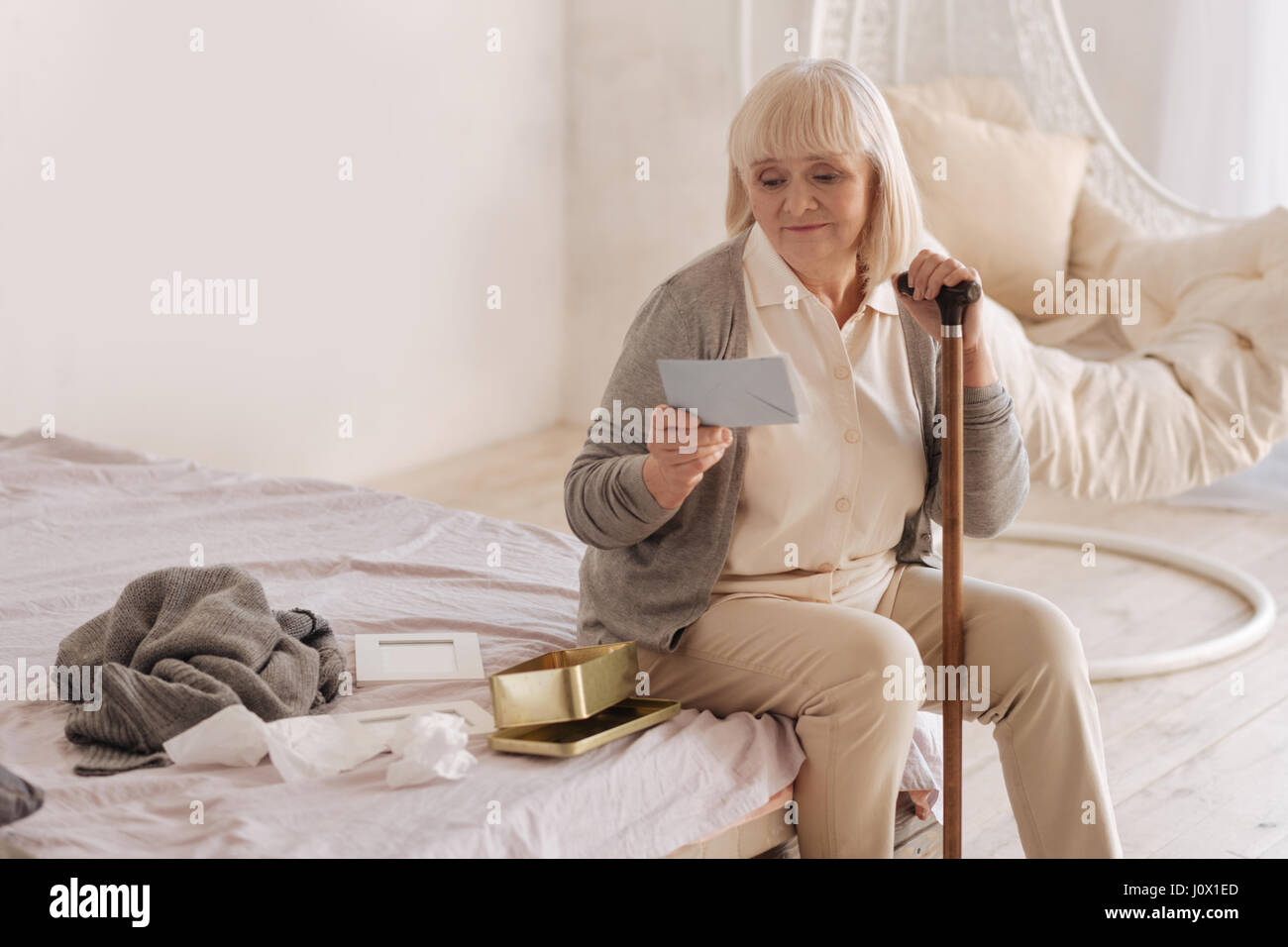 Sad unhappy woman holding a letter Stock Photo - Alamy
