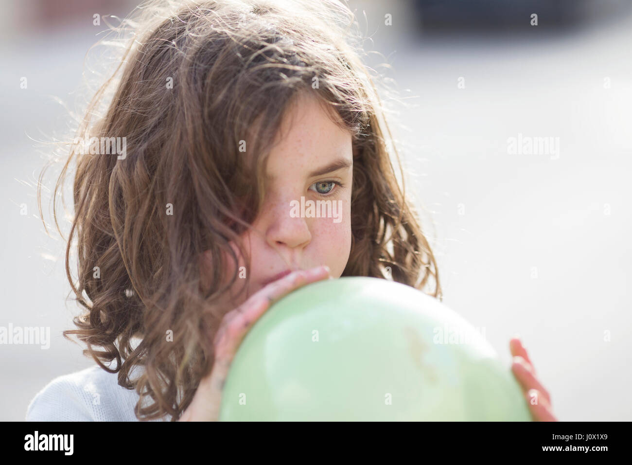 Girl blowing up balloon hi-res stock photography and images - Alamy