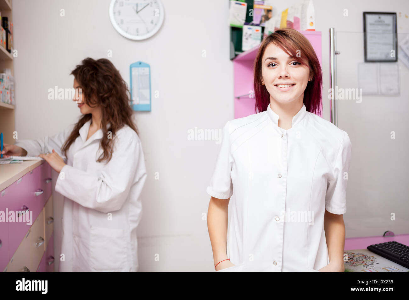 Two pharmacist woman at work place Stock Photo - Alamy