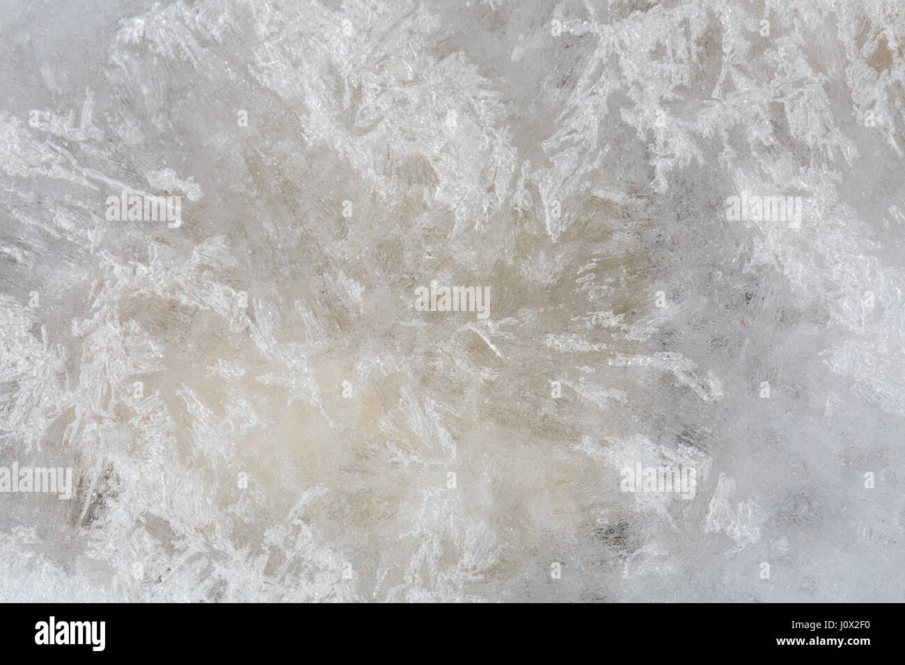 Ice lines the stream flowing Stock Photo - Alamy