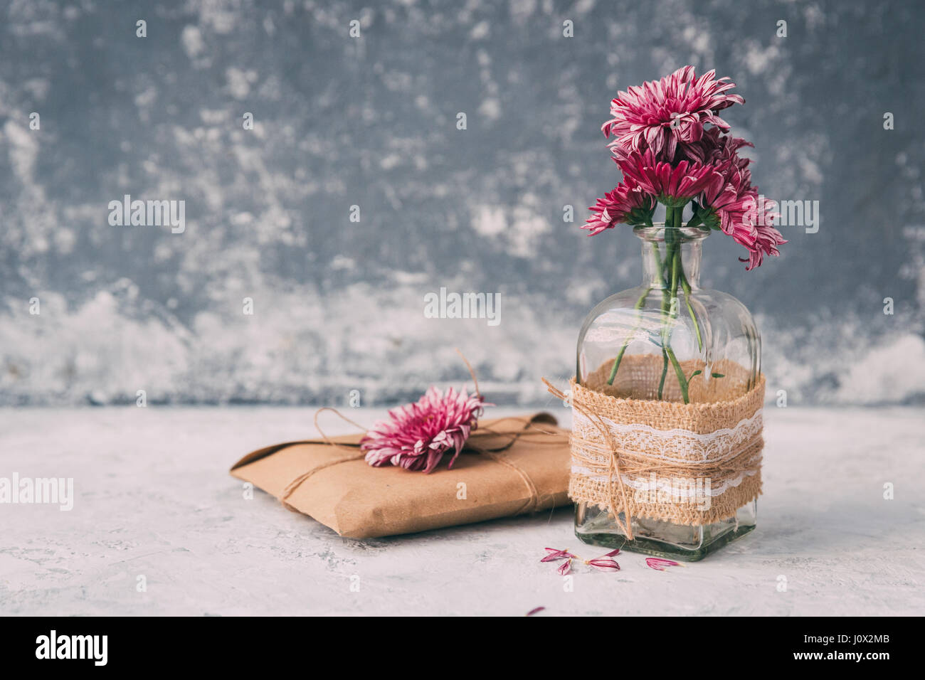 Envelope and vase with pink flowers Stock Photo - Alamy