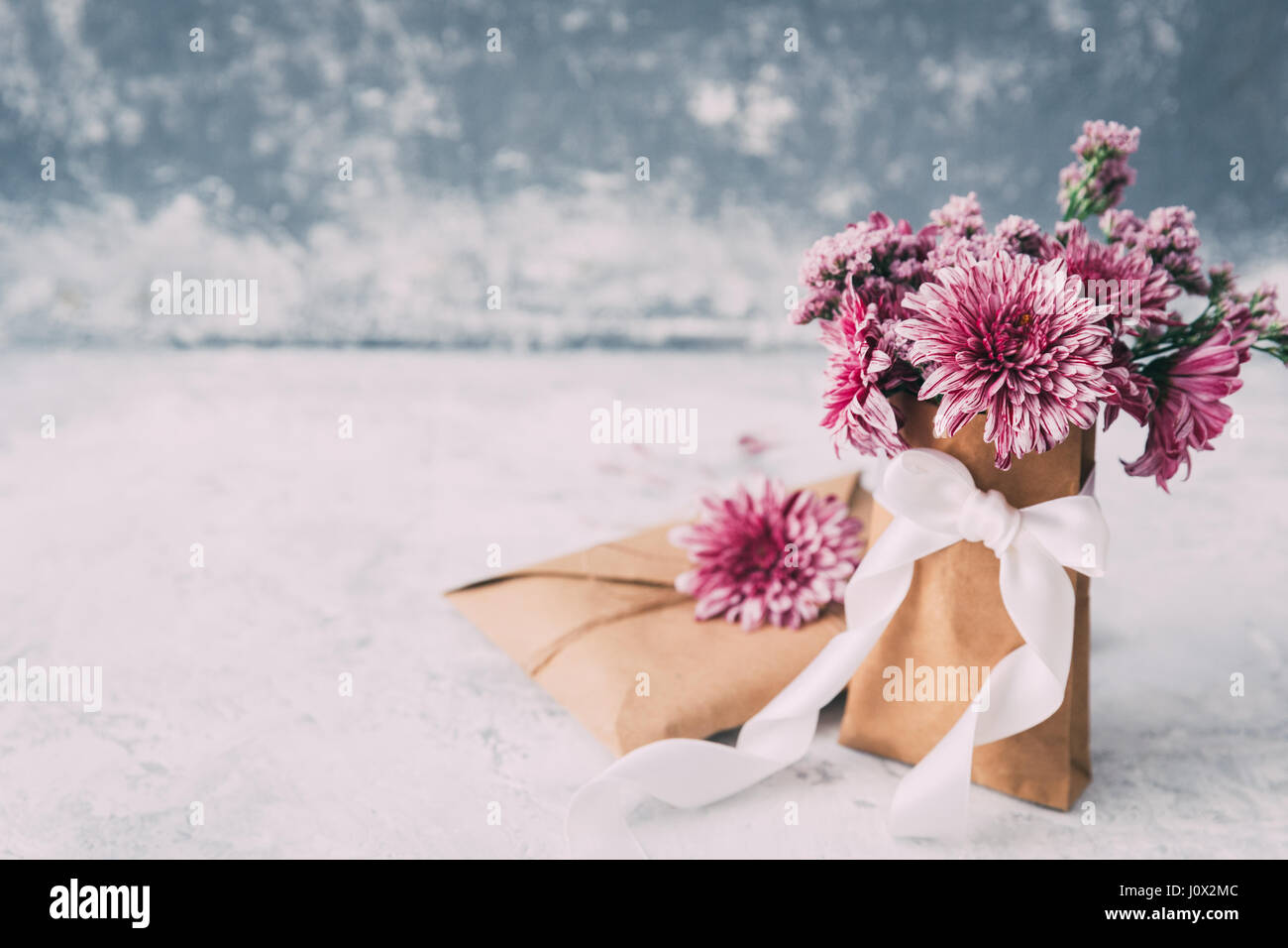 Envelope and vase with pink flowers Stock Photo - Alamy