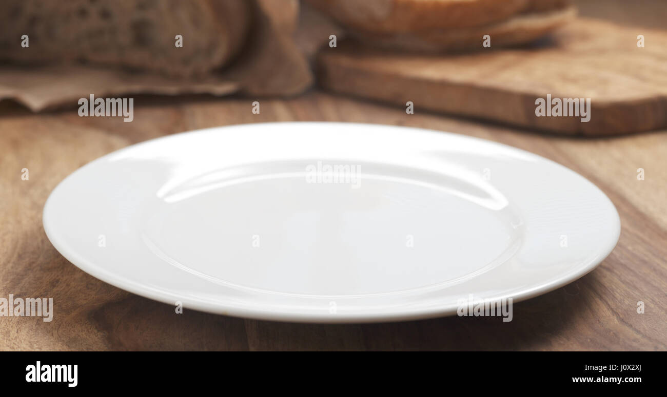 empty white plate on wood table for your dish Stock Photo - Alamy