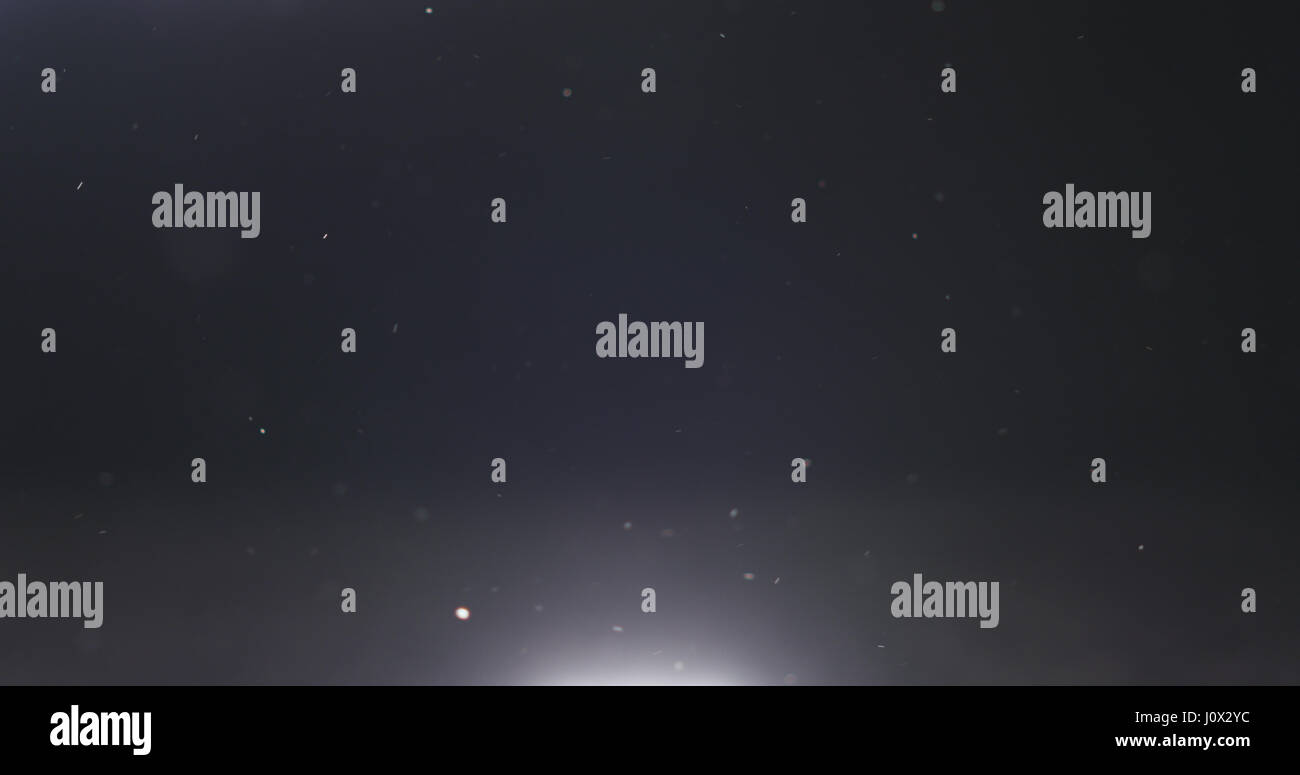 dust particles fast moving over black background from below Stock Photo ...