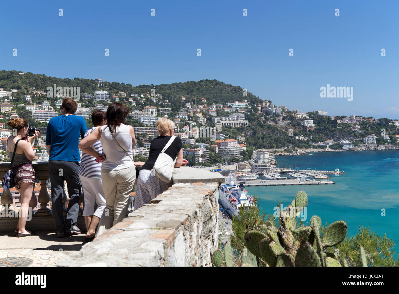 France, Nice, tourists admiring the view over Nice harbour and along ...