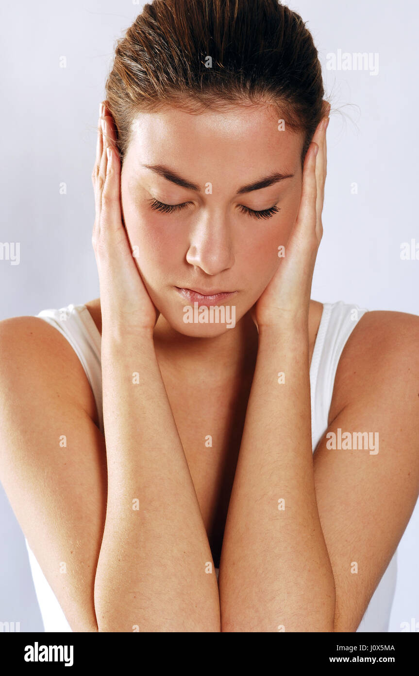 Close up of woman covering her ears Stock Photo - Alamy