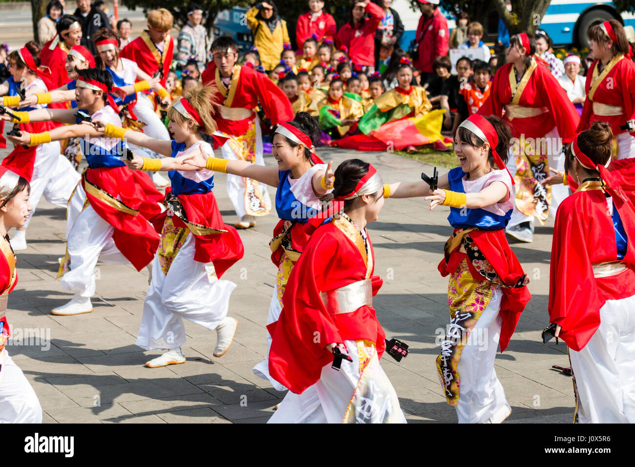 Japan, Kumamoto, Hinokuni Yosakoi Dance festival. Dance team in red ...
