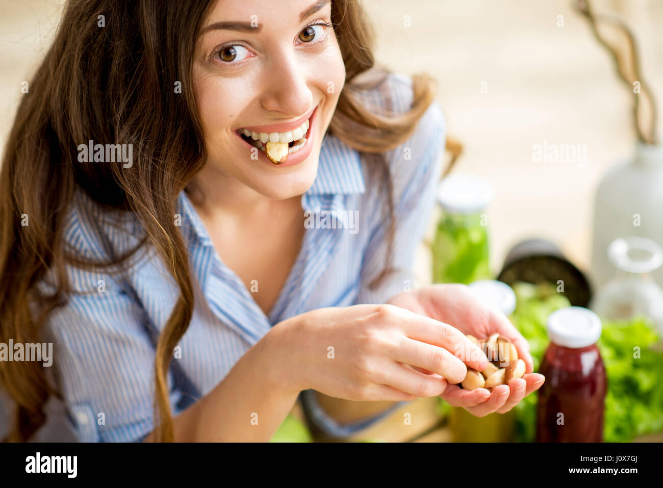 Woman eating nuts Stock Photo - Alamy