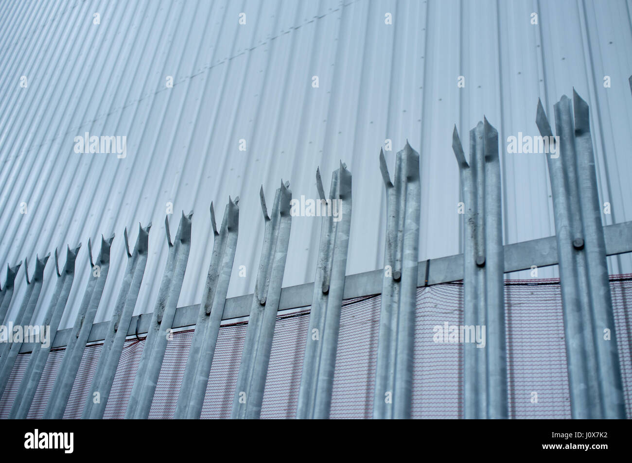 Security fence with pointed spike infront of a warehouse Stock Photo ...