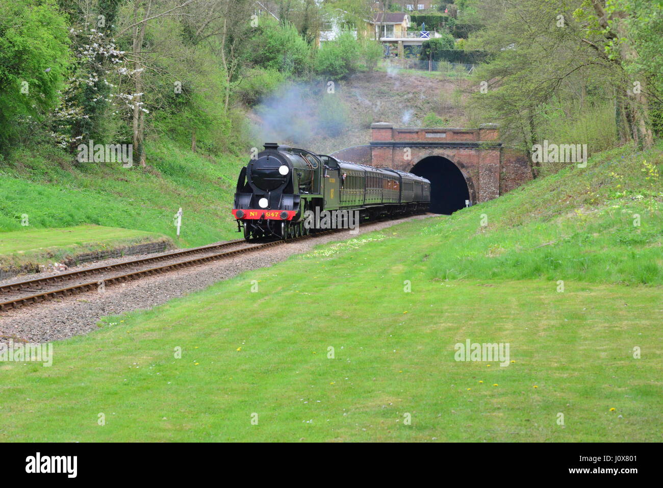 A vintage English steam locomotive on a dull spring afternoon in April ...