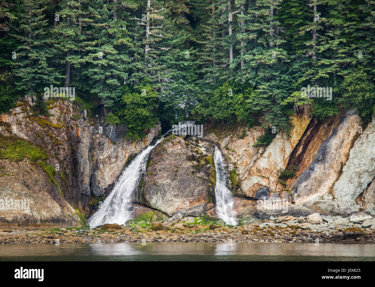 Small waterfall on the coast of Alaska. Alaska. USA Stock Photo - Alamy