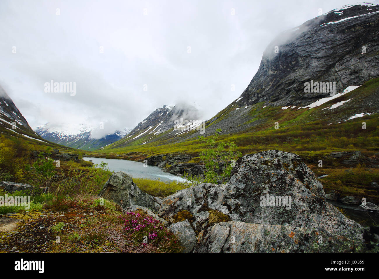 Beautiful spring Norway mountains and river with melting snow on tops ...