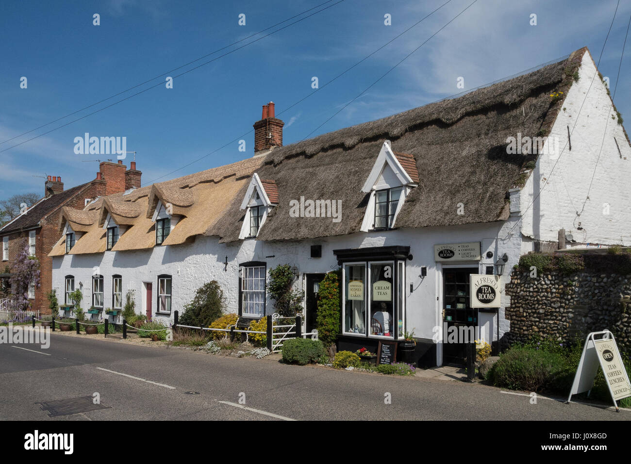 Thatched cottages and tea room in the village of Ludham in Norfolk ...