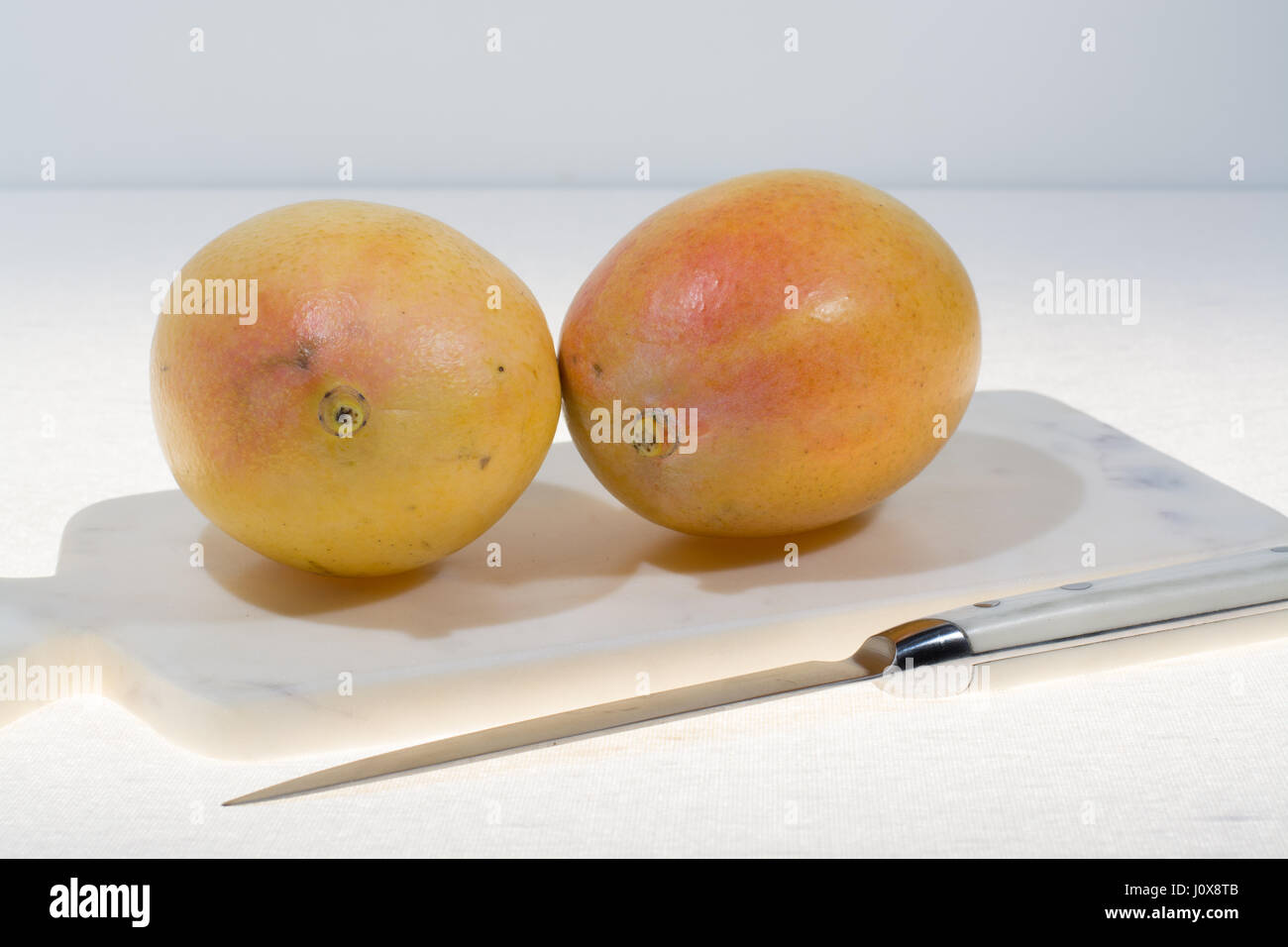 Two ripe organic golden yellow mangoes ready to eat close up Stock ...