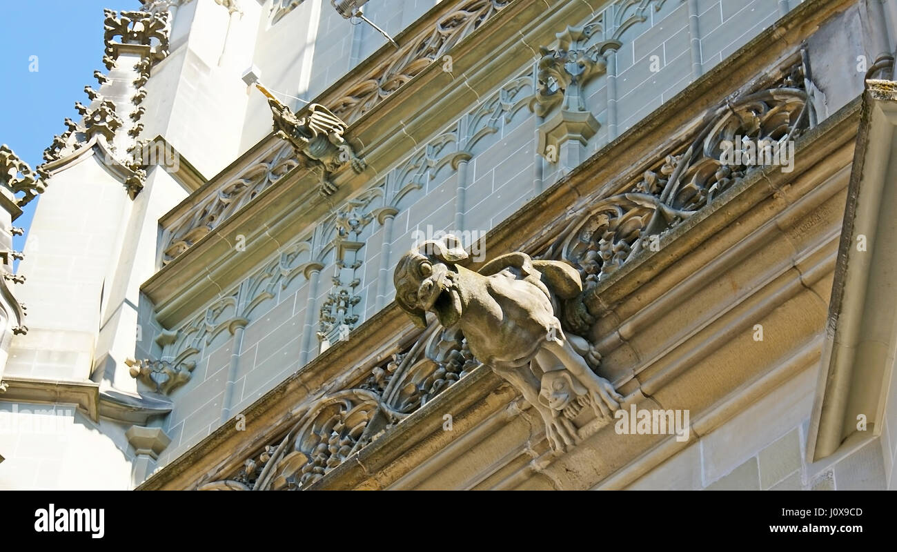 The walls of Gothic Minster Cathedral decorated with stone gargoyles ...