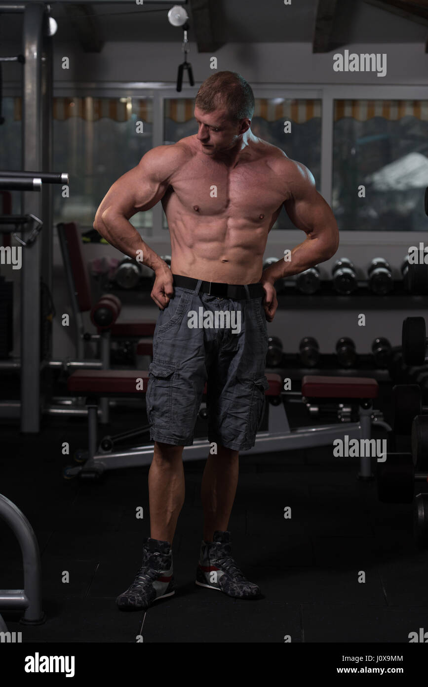 Healthy Man Standing Strong In The Gym And Flexing Muscles - Muscular ...