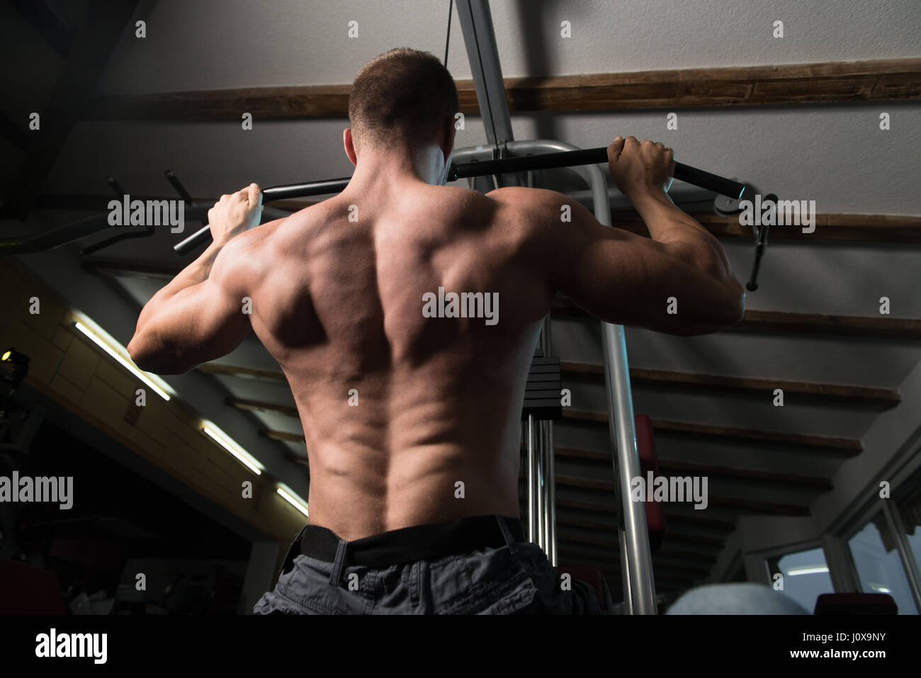 Bodybuilder Doing Heavy Weight Exercise For Back On Machine Stock Photo ...