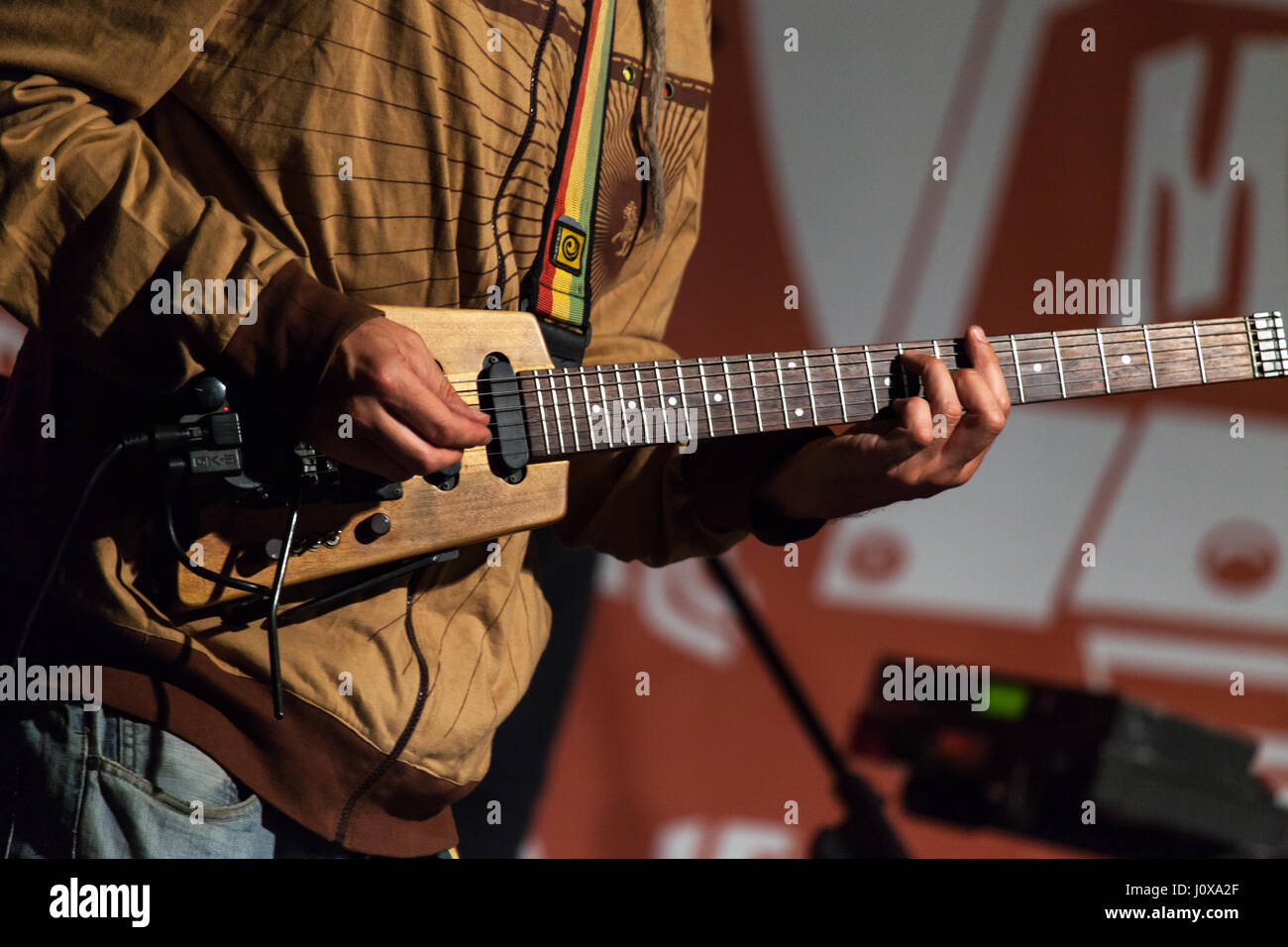 rock musician playing the bass in a live concert Stock Photo - Alamy