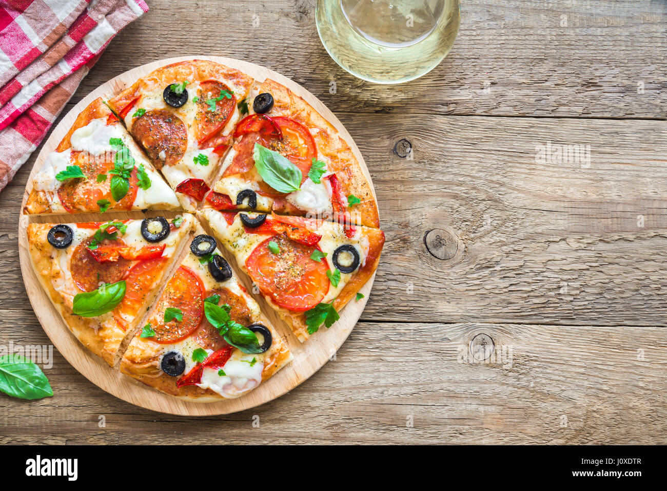 Italian Pizza with Tomatoes, Salami, black Olives and Mozzarella Cheese ...