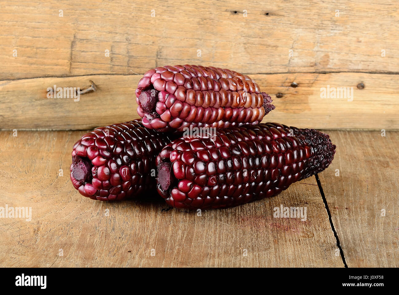 Red corn on the wooden background Stock Photo - Alamy