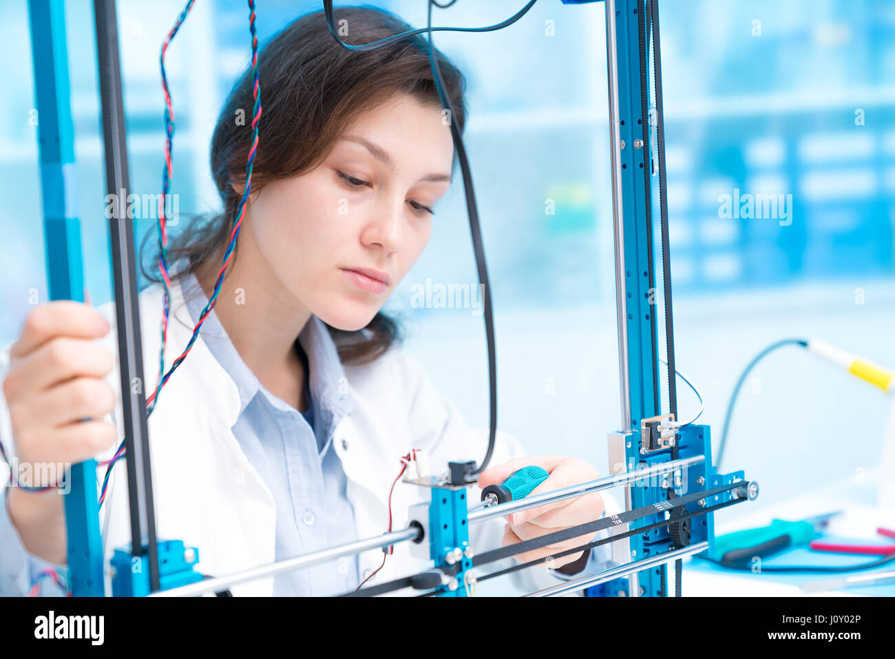 girl in robotics class research electronic device. Details of the ...