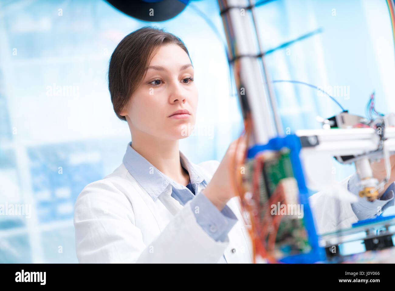 girl in robotics class research electronic device. Details of the ...