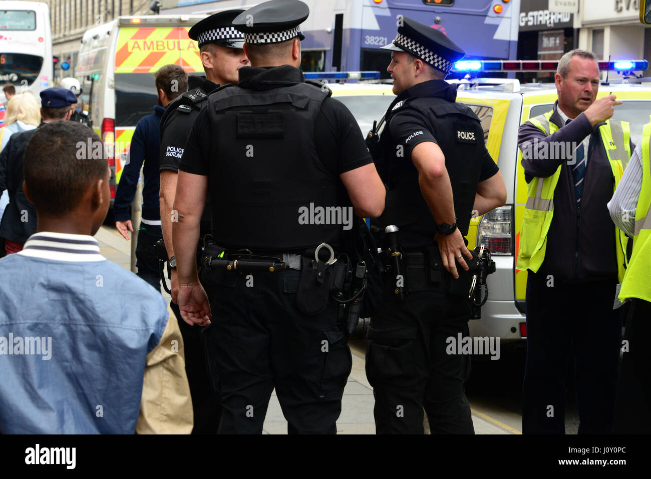 Armed police who were on routine patrol in Glasgow attend a road ...