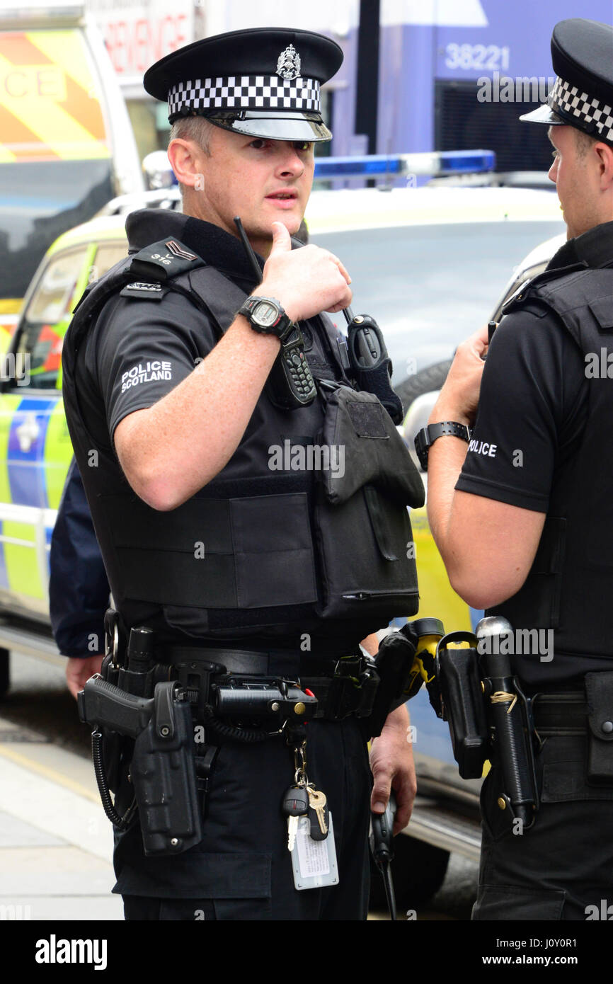 Armed police who were on routine patrol in Glasgow attend a road ...
