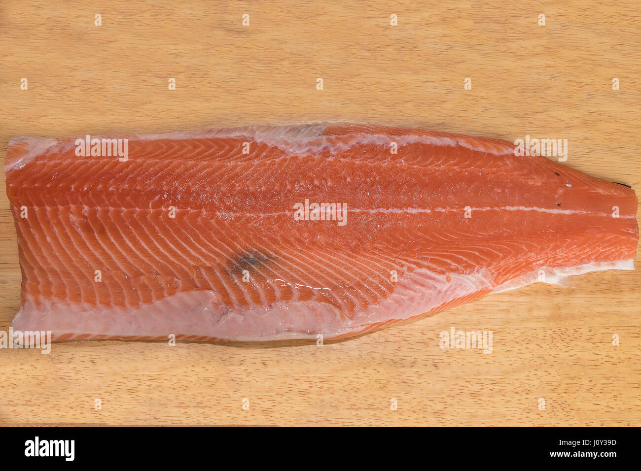 Salmon side on a wooden background Stock Photo - Alamy