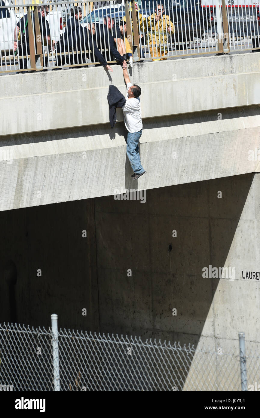 LAPD firefighters try to rescue a man threatening to jump from the ...