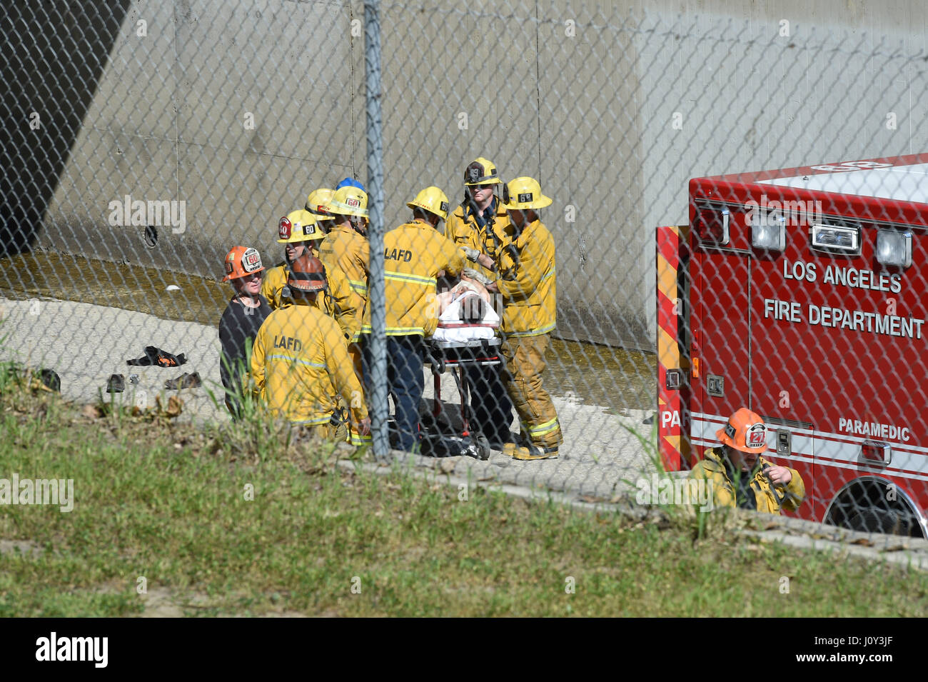 LAPD firefighters try to rescue a man threatening to jump from the ...
