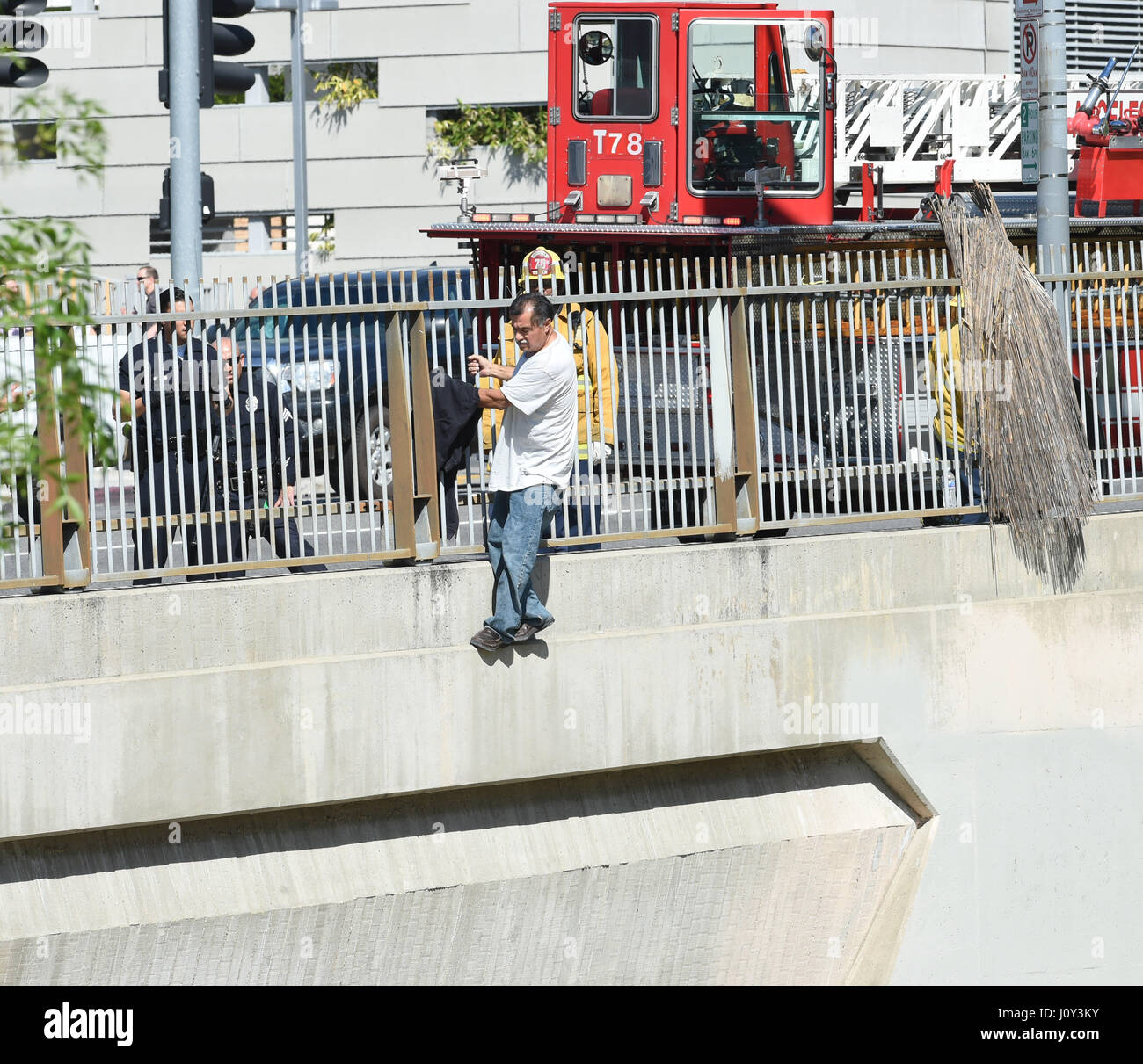 LAPD firefighters try to rescue a man threatening to jump from the ...