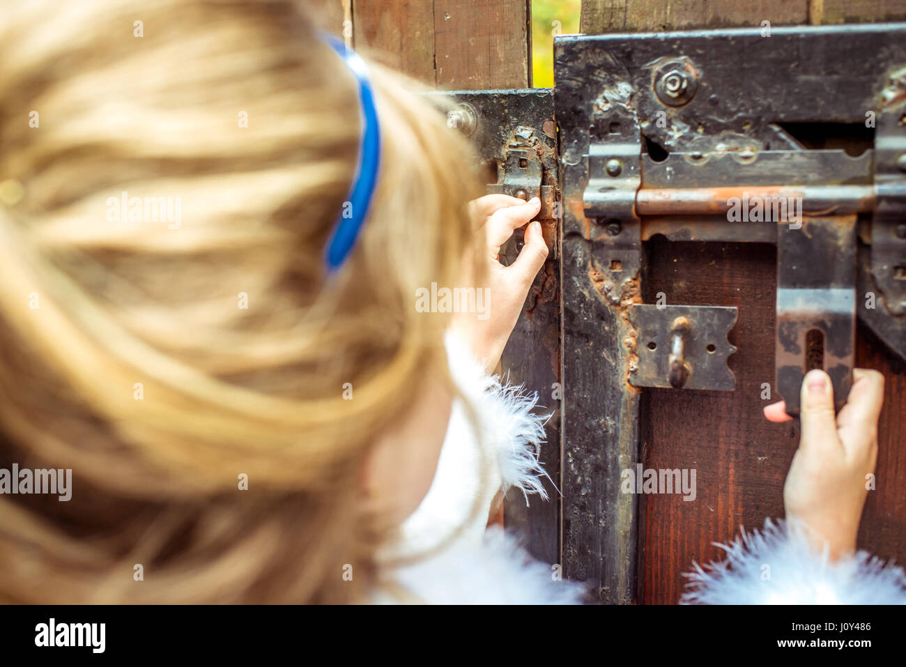 Girl looking keyhole hi-res stock photography and images - Alamy