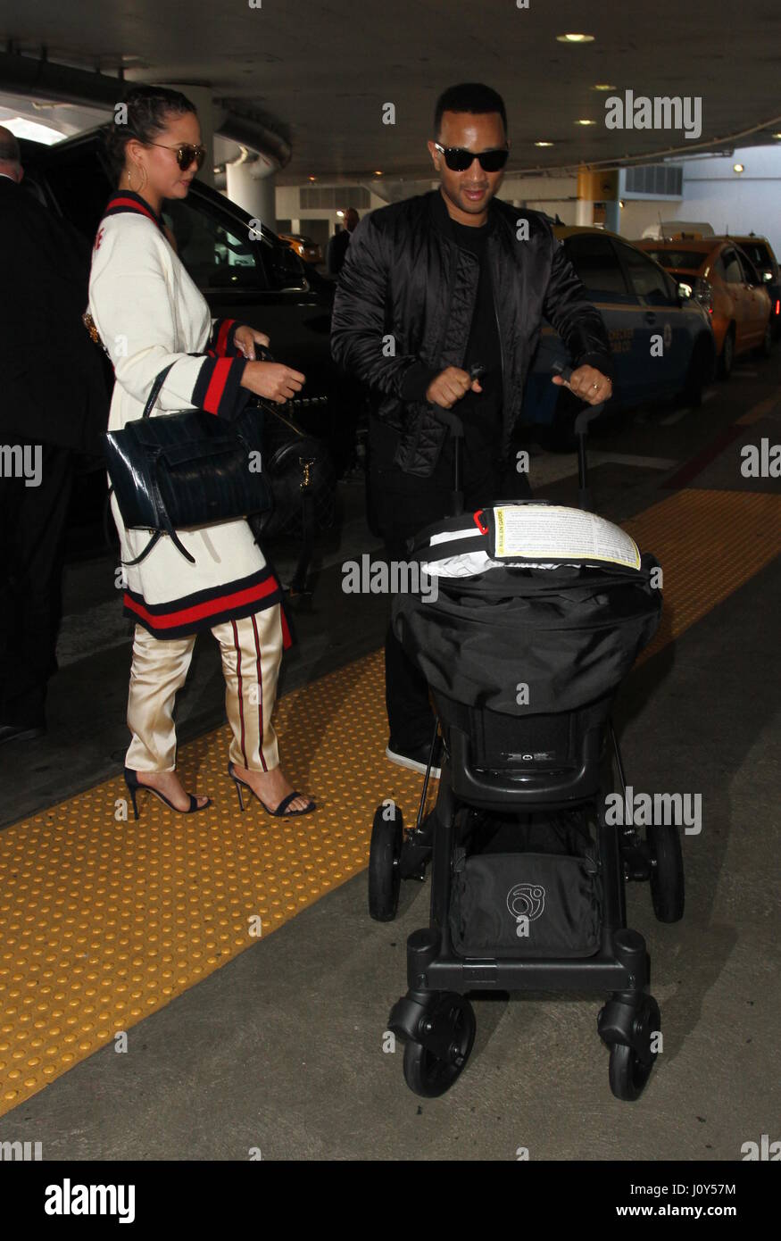 Chrissy Teigen and John Legend arrive at the airport with their ...
