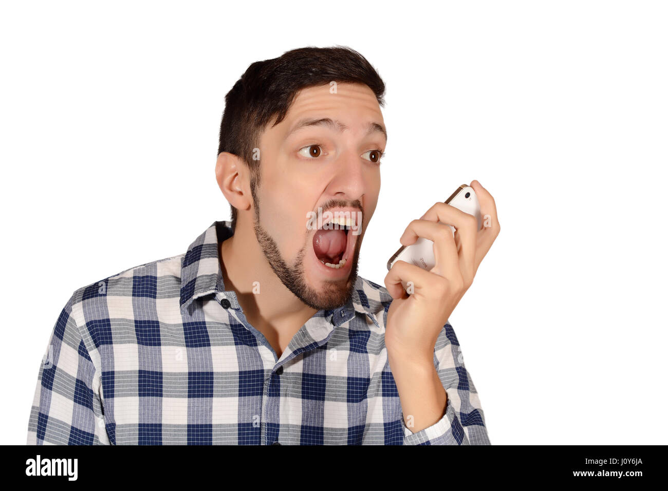 Portrait of a young handsome man talking on the phone. Isolated white ...