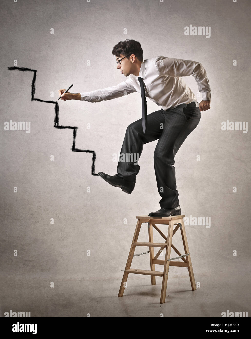 Businessman drawing stairs to step on Stock Photo - Alamy