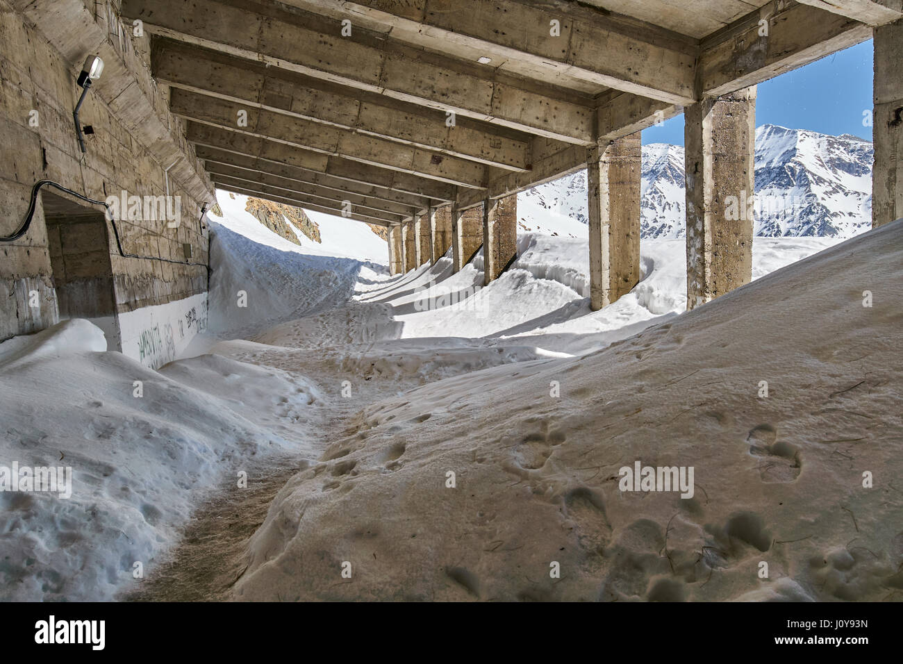 Mountain road in snow drift through a passage Stock Photo - Alamy