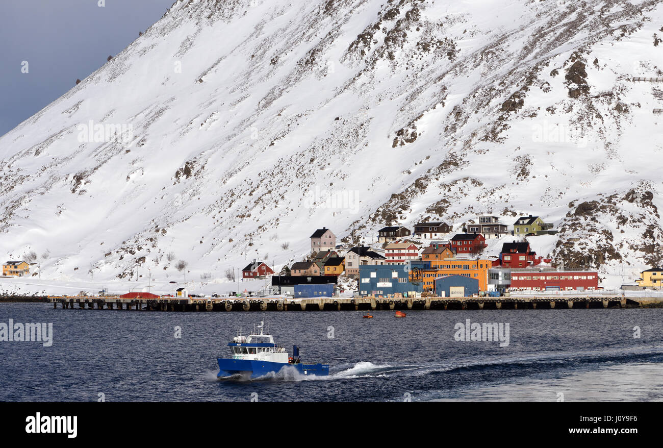 A small fishing boat leaves the quay at Honningsvag, the northernmost ...