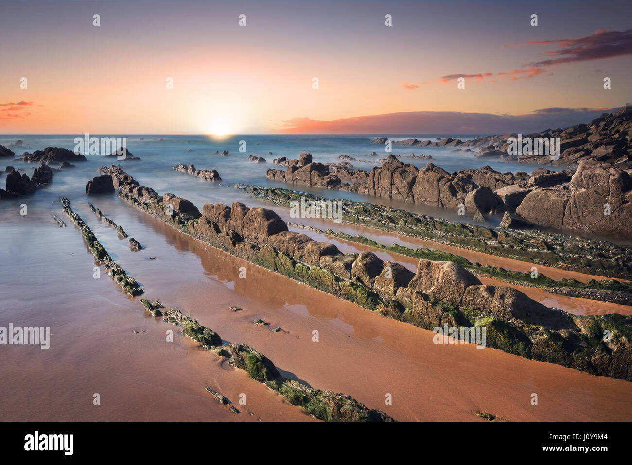 Scenic Sunset at barrika beach, mossy rocks. Bilbao, Basque country ...