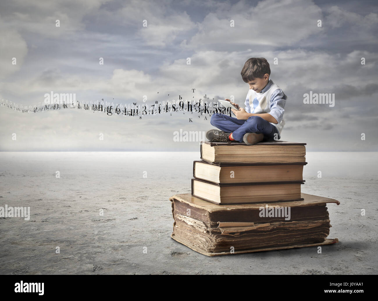 Little boy reading, letters coming out of book Stock Photo - Alamy