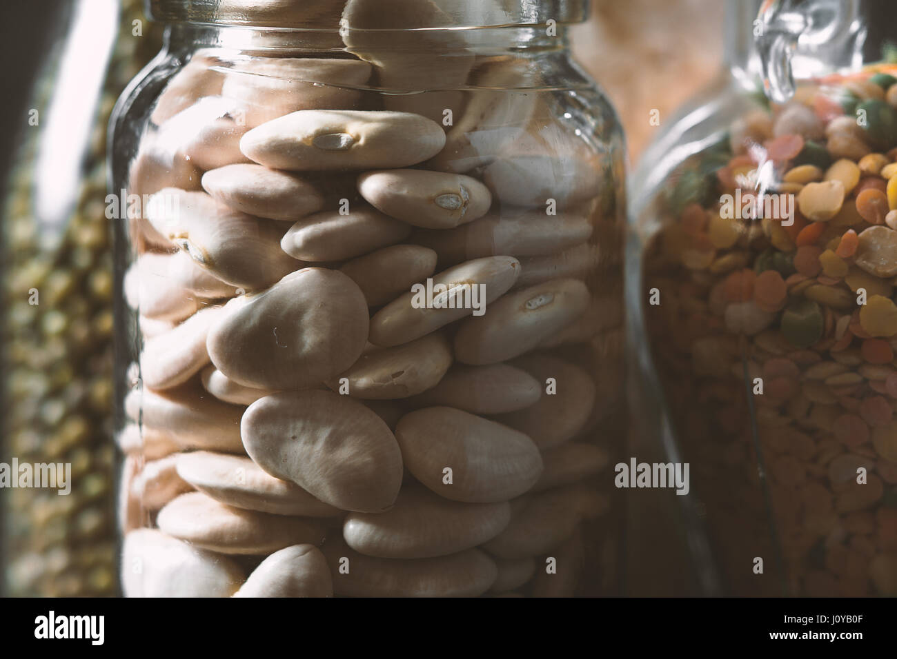Large white beans in a glass jar is a side view horizontal Stock Photo ...