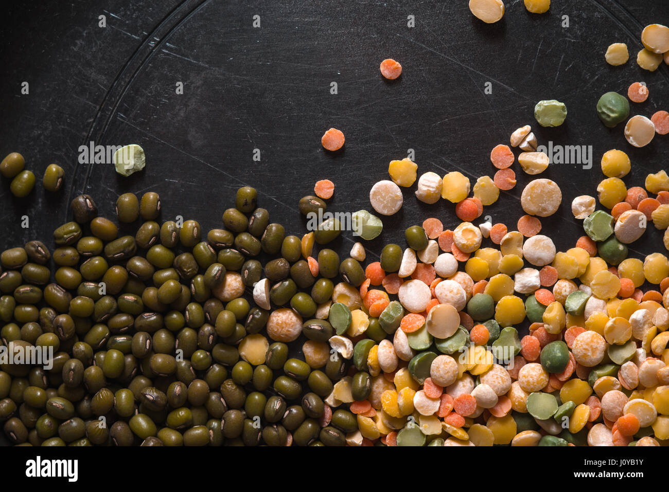 Placer lentils and green beans on a black table horizontal Stock Photo ...